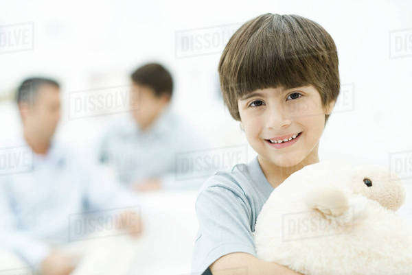 Boy holding stuffed toy, smiling, portrait - Royalty-free Stock Photo ...