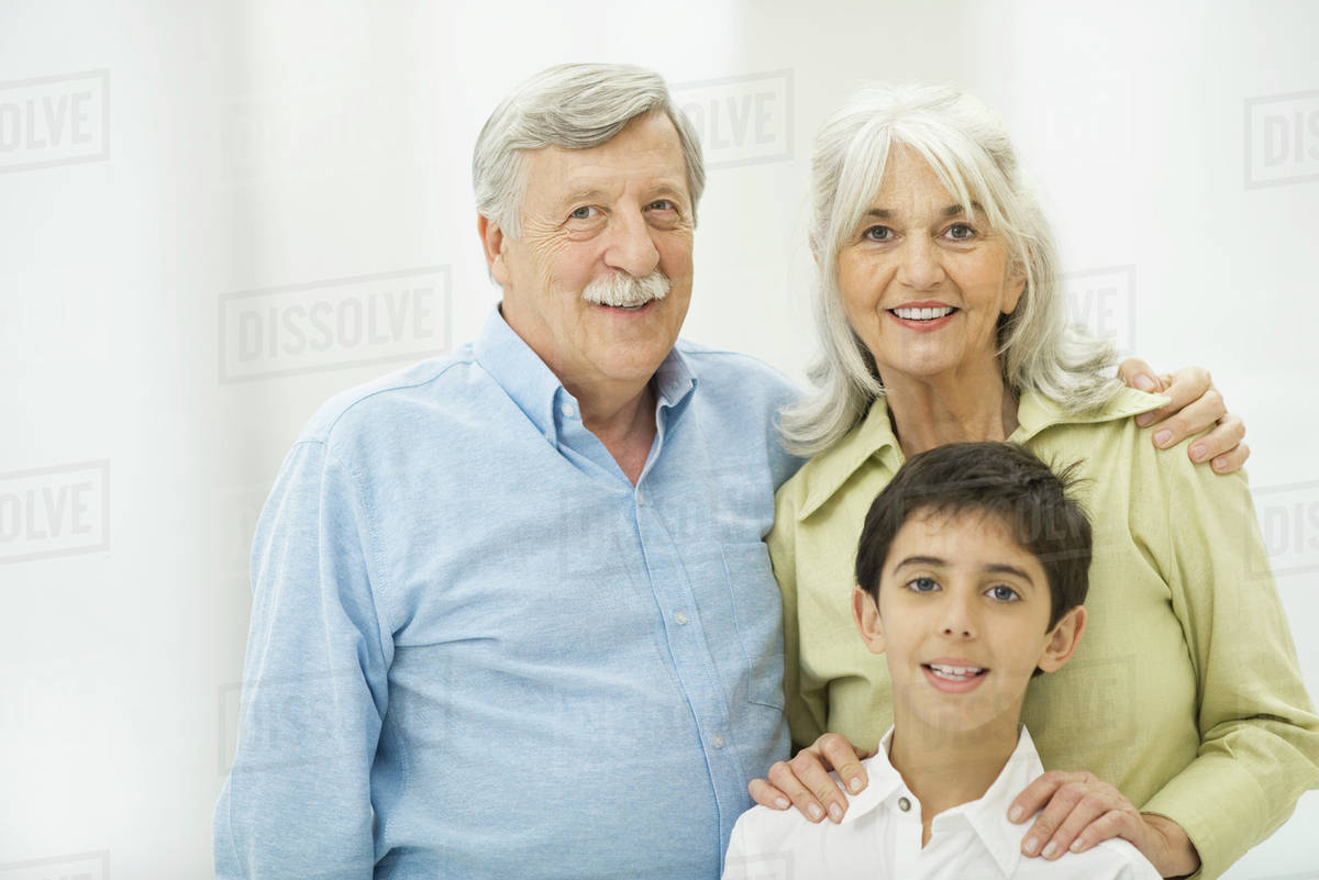 Grandparents and grandson smiling at camera, portrait - Royalty-free ...