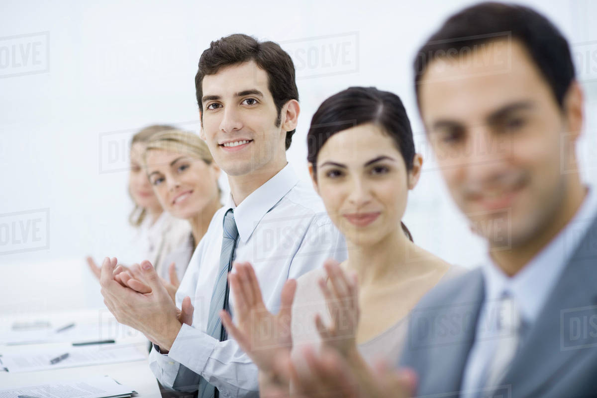 Group of professionals clapping, smiling at camera - Royalty-free Stock ...