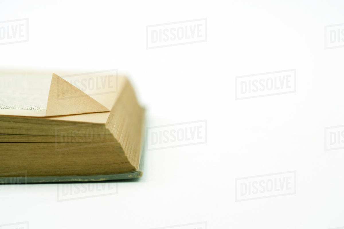 Corner of book, yellowed corner of top page folded up, close-up ...