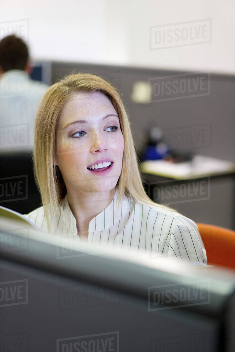 Intern cheerfully working in office cubicle - Royalty-free Stock Photo ...