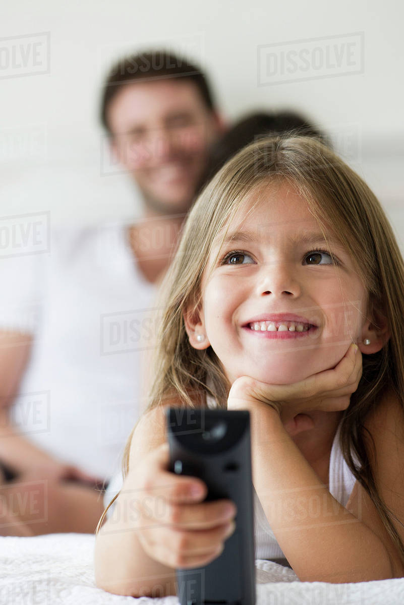 Little girl holding remote control - Royalty-free Stock Photo | Dissolve