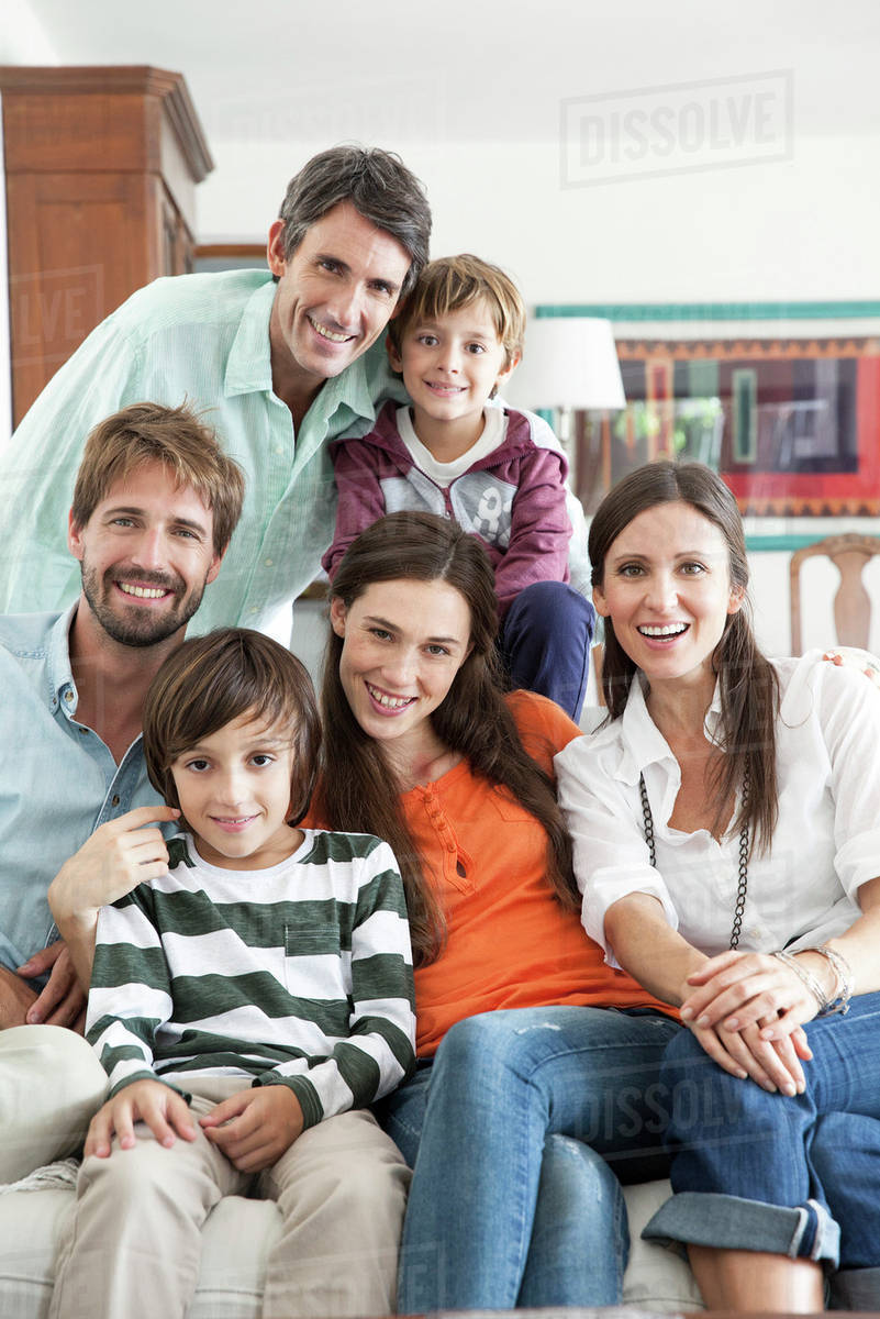 Family together in living room, portrait - Stock Photo - Dissolve
