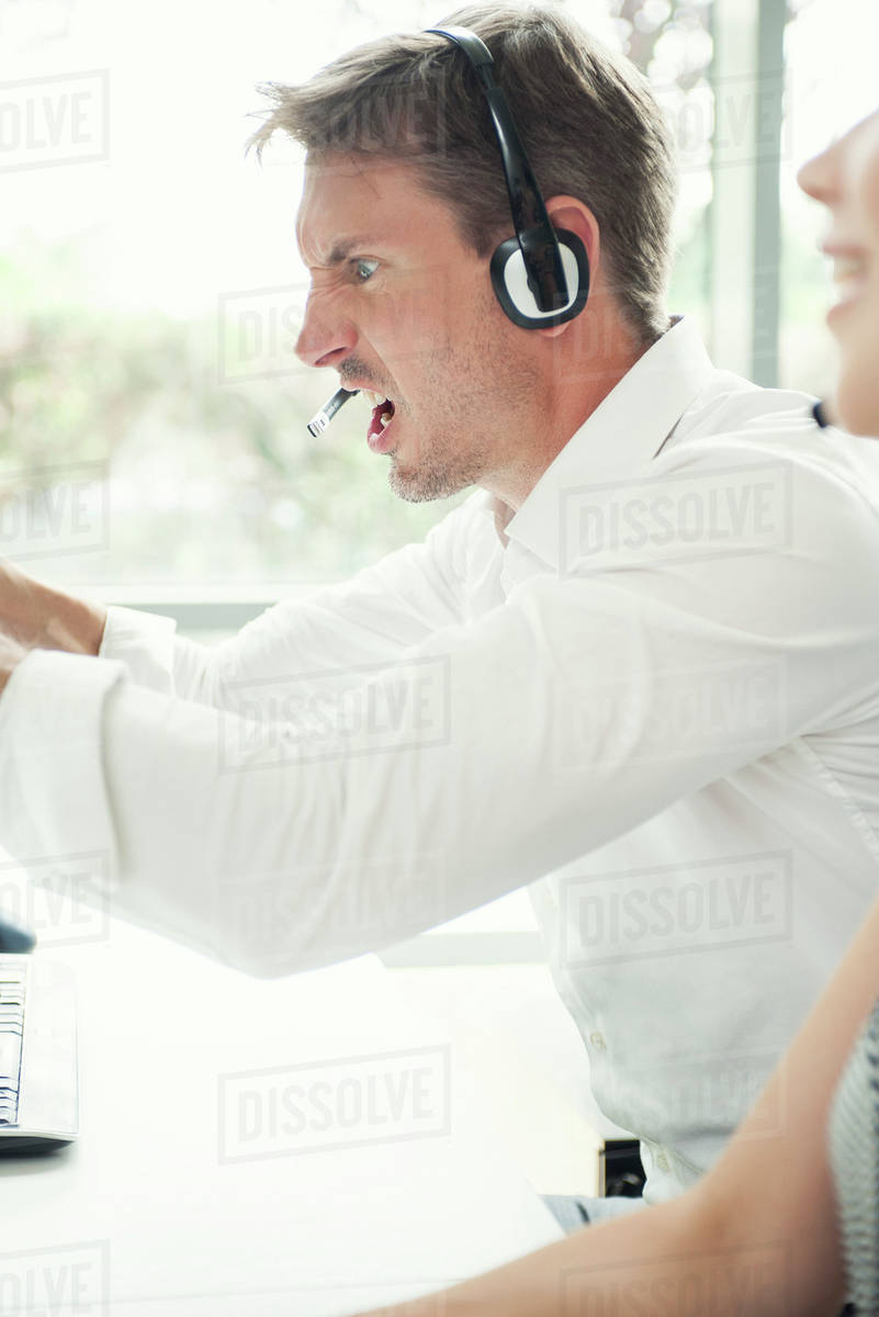 Frustrated call center worker - Royalty-free Stock Photo | Dissolve