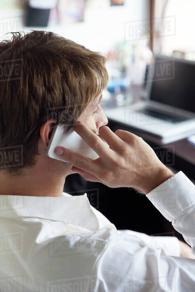 Office worker using cell phone, side view - Royalty-free Stock Photo ...