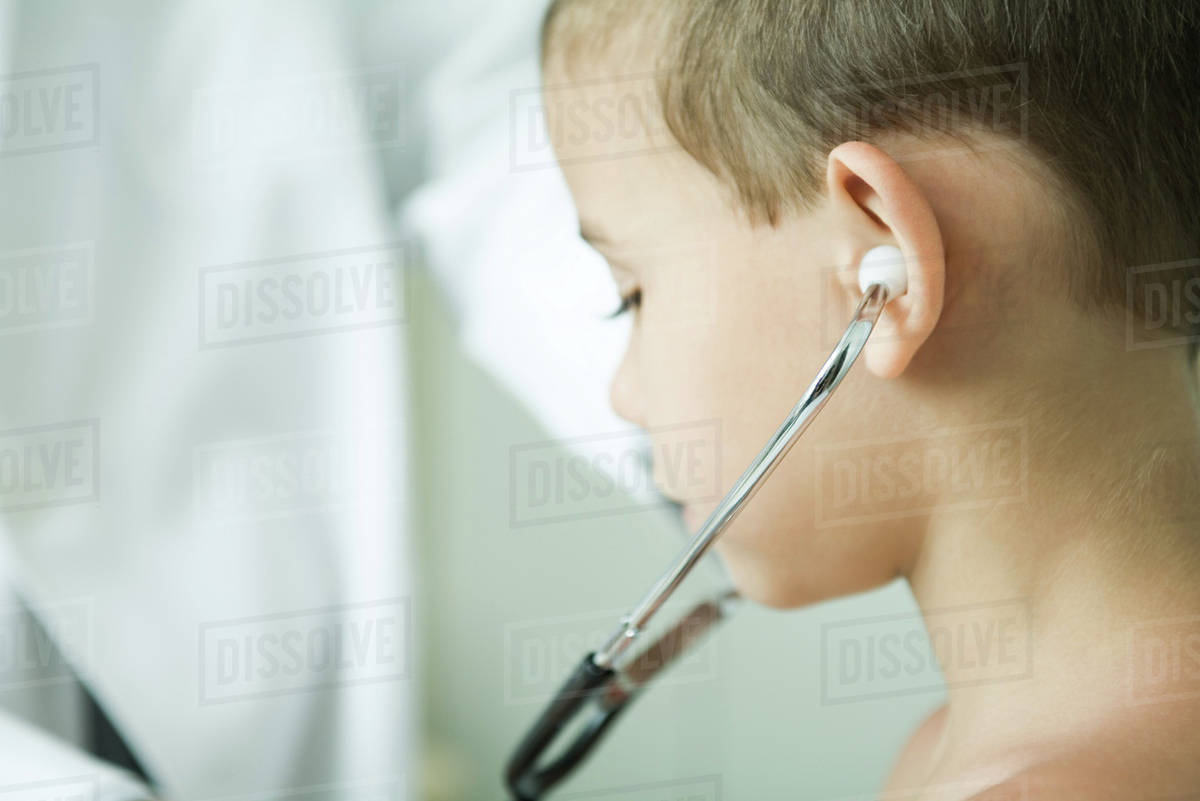 Boy listening to stethoscope - Royalty-free Stock Photo | Dissolve