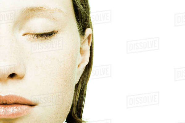 Teenage girl, eye closed, cropped front view of face - Royalty-free ...