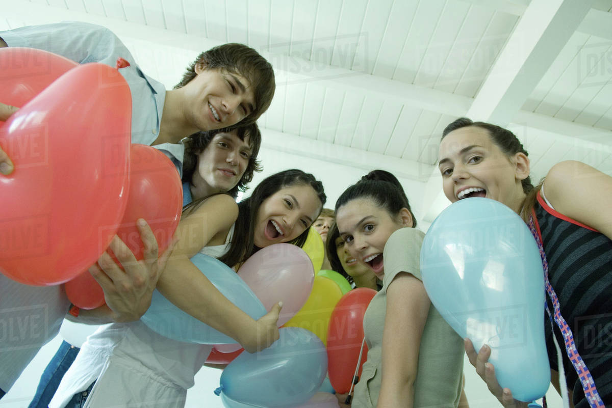 Teenage friends holding balloons - Royalty-free Stock Photo | Dissolve