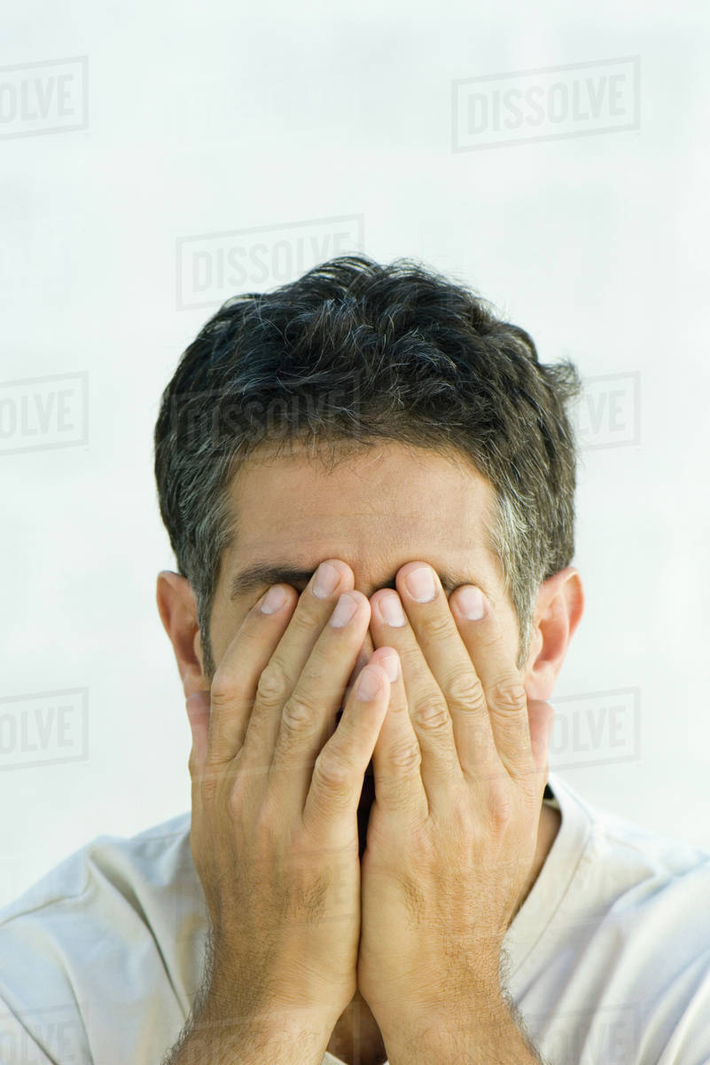 Man covering face with hands, head and shoulders, portrait - Royalty ...