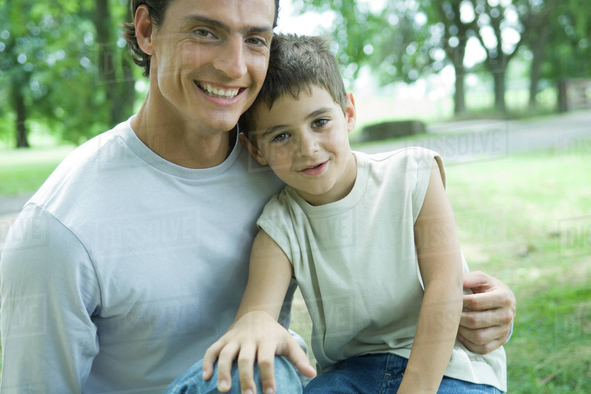 Boy sitting on father's lap - Royalty-free Stock Photo | Dissolve