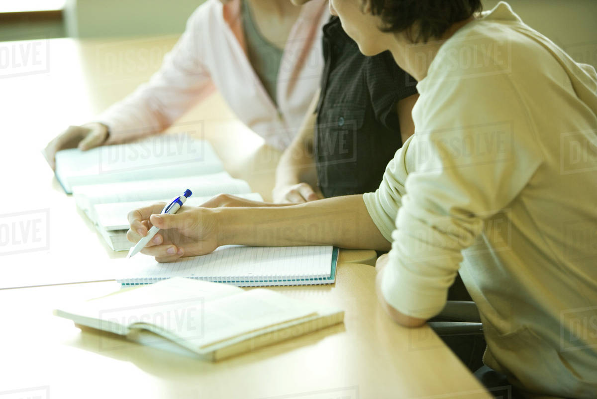 College students sitting at table studying, partial view - Royalty-free ...