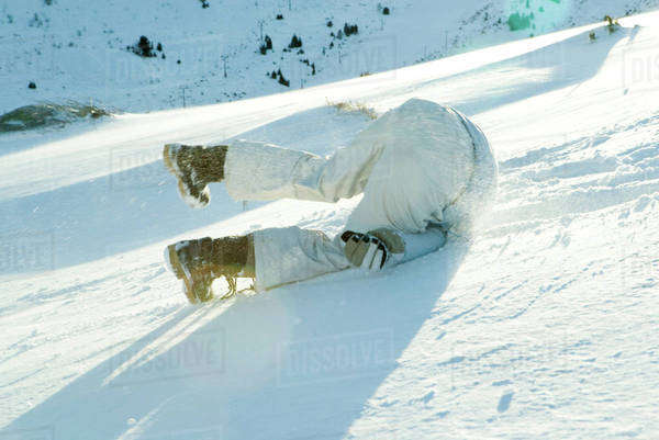 Young skier falling down hill, rear view - Royalty-free Stock Photo ...