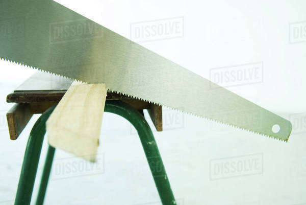 Saw cutting wood plank, close-up - Royalty-free Stock Photo | Dissolve