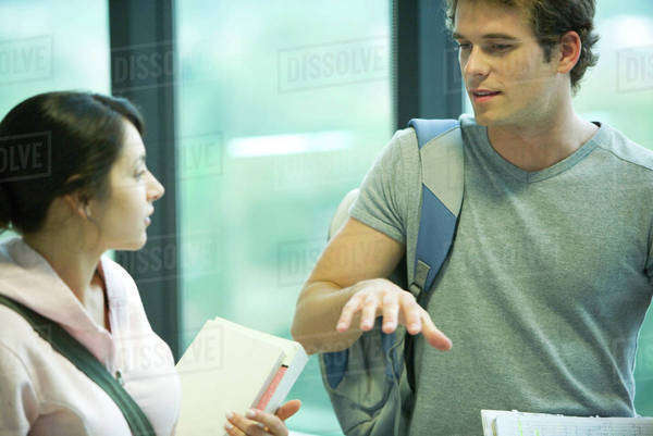 Two students standing together, chatting - Royalty-free Stock Photo ...