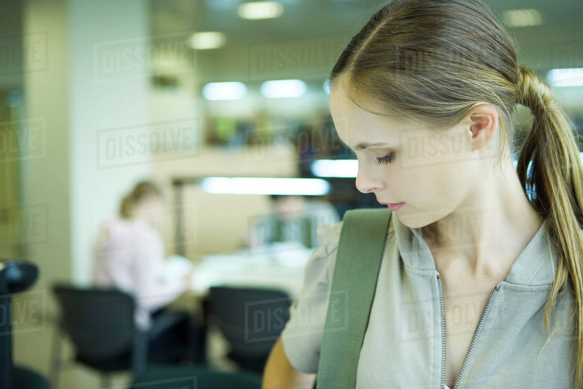 Female student looking down, head and shoulders - Stock Photo - Dissolve