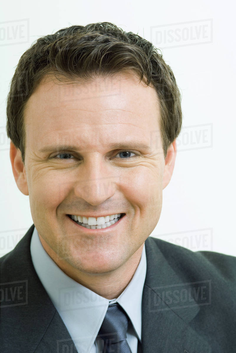Businessman smiling at camera, portrait - Royalty-free Stock Photo ...