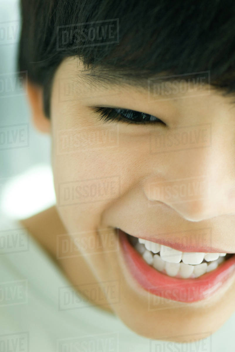 Cropped view of boy laughing, portrait - Stock Photo - Dissolve