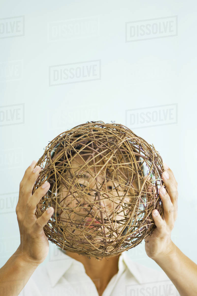 Man holding up wicker sphere in front of face - Royalty-free Stock ...