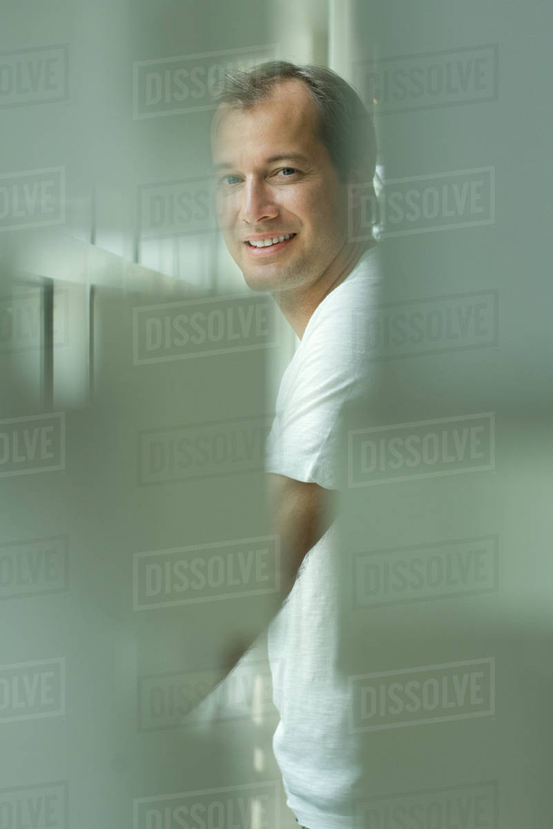 Man smiling over shoulder at camera, selective focus - Stock Photo ...