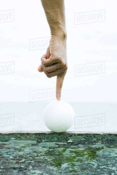 Hand touching ball with forefinger, cropped view - Royalty-free Stock ...
