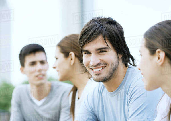 Group of young adults in urban park - Stock Photo - Dissolve