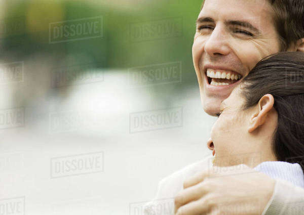 Young couple laughing, woman resting head on man's shoulder - Stock ...
