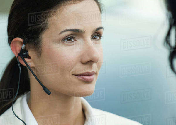 Woman wearing headset - Royalty-free Stock Photo | Dissolve
