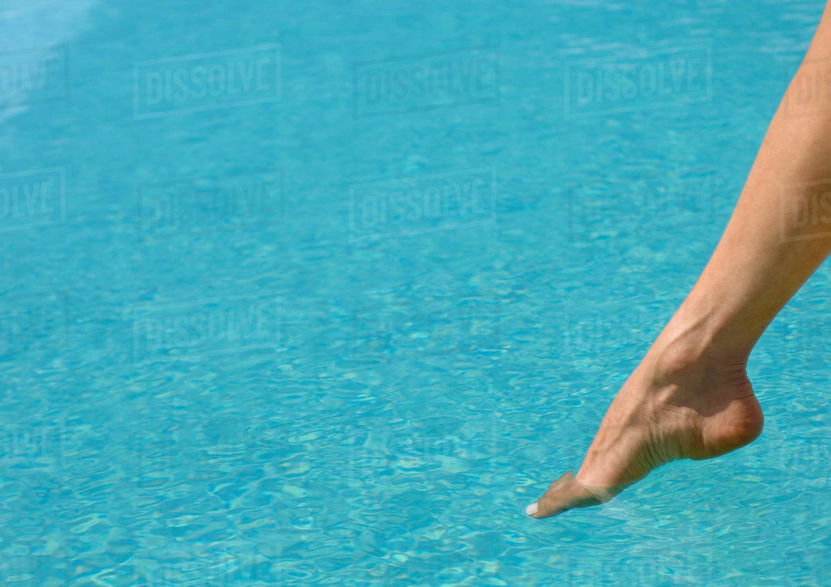 Woman's foot, testing water in pool - Royalty-free Stock Photo | Dissolve