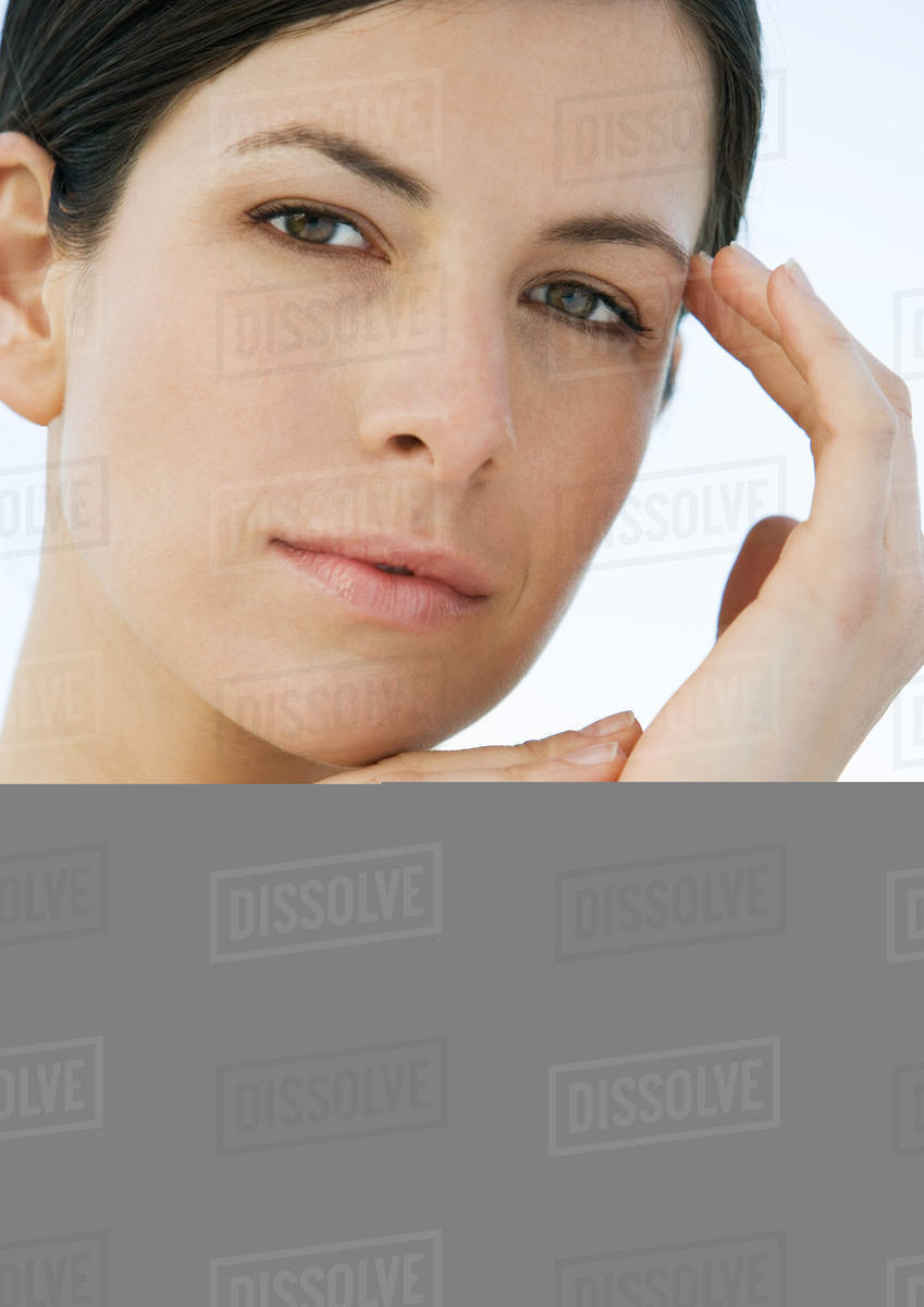 Woman with hands near face, portrait - Stock Photo - Dissolve