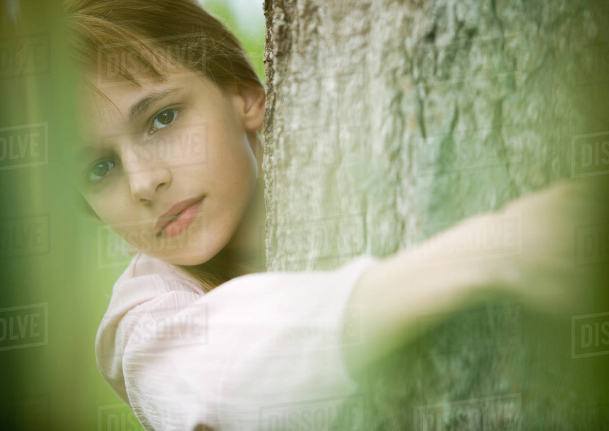 Girl hugging tree - Stock Photo - Dissolve