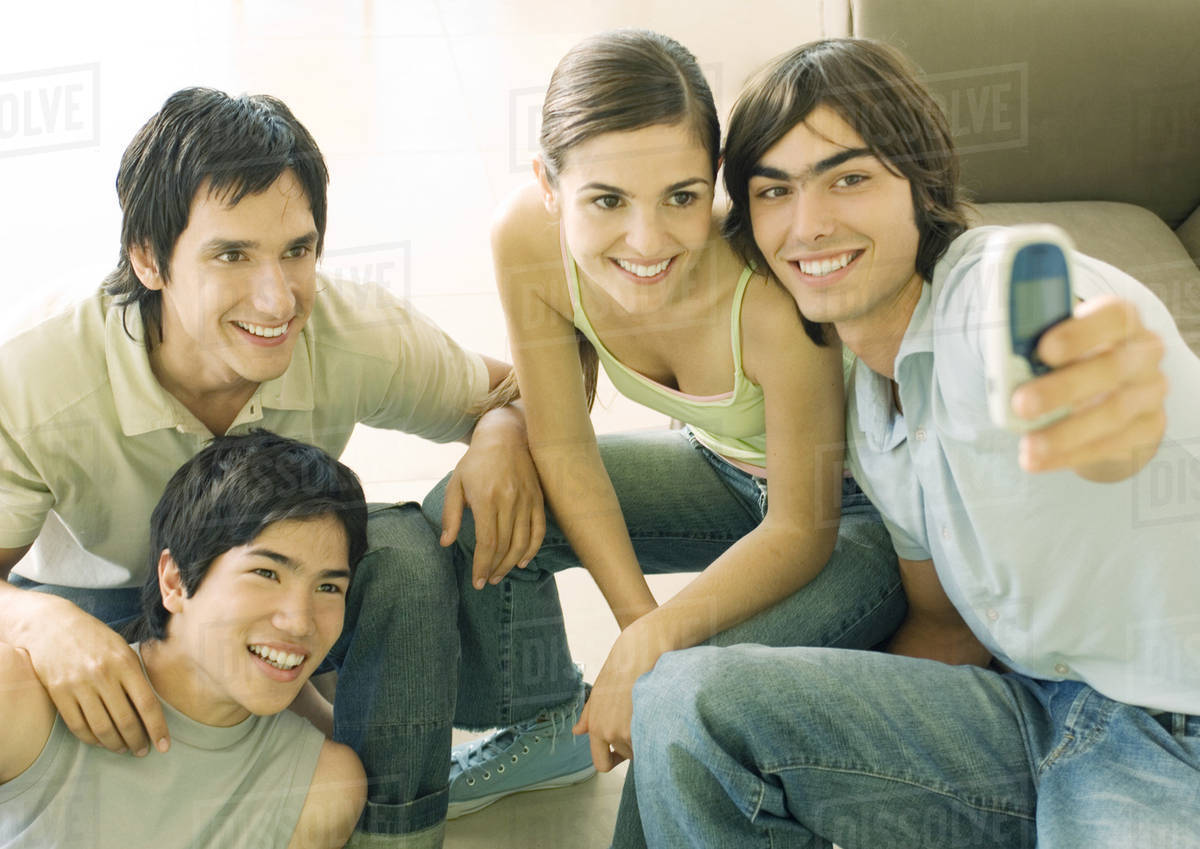 Taking group photo with cell phone - Stock Photo - Dissolve