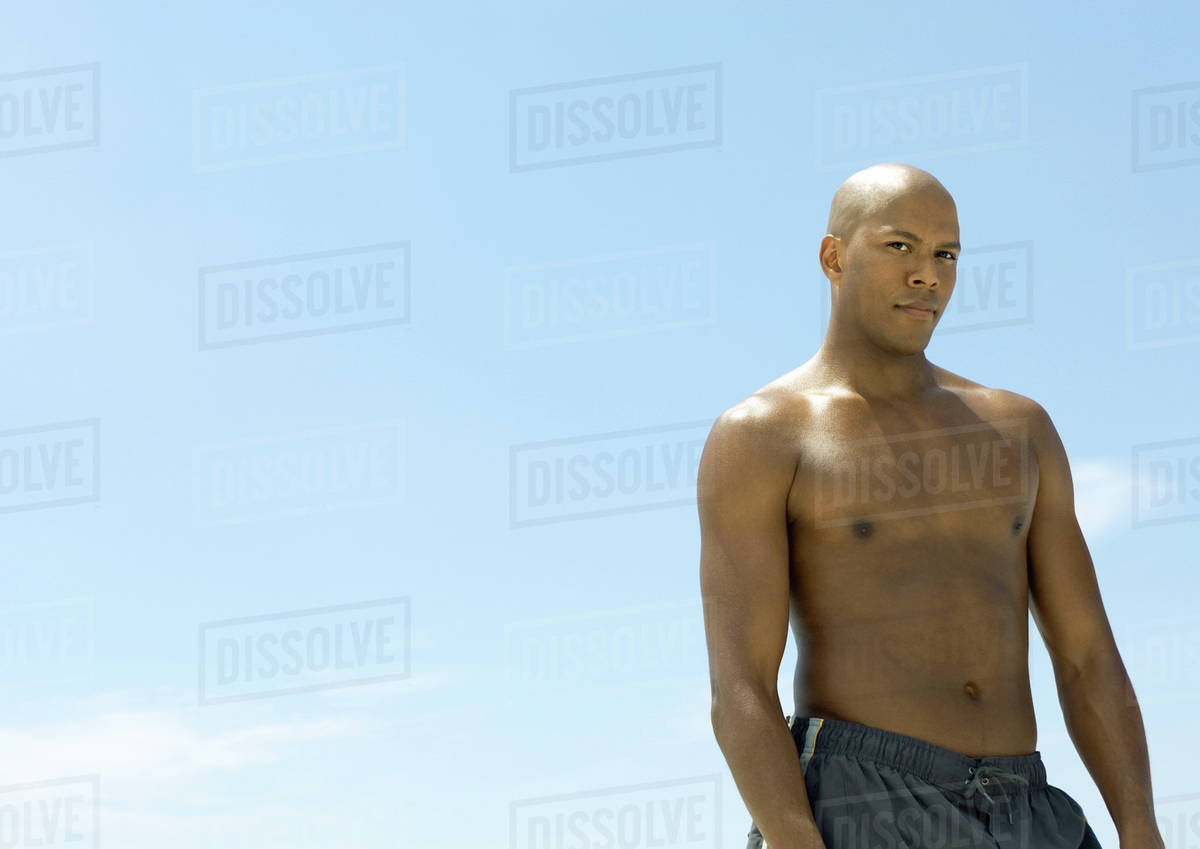 Man standing in sun - Royalty-free Stock Photo | Dissolve