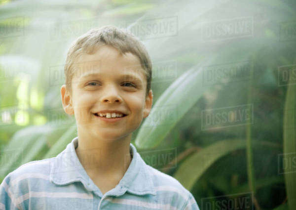 Boy standing in mist, smiling - Royalty-free Stock Photo | Dissolve
