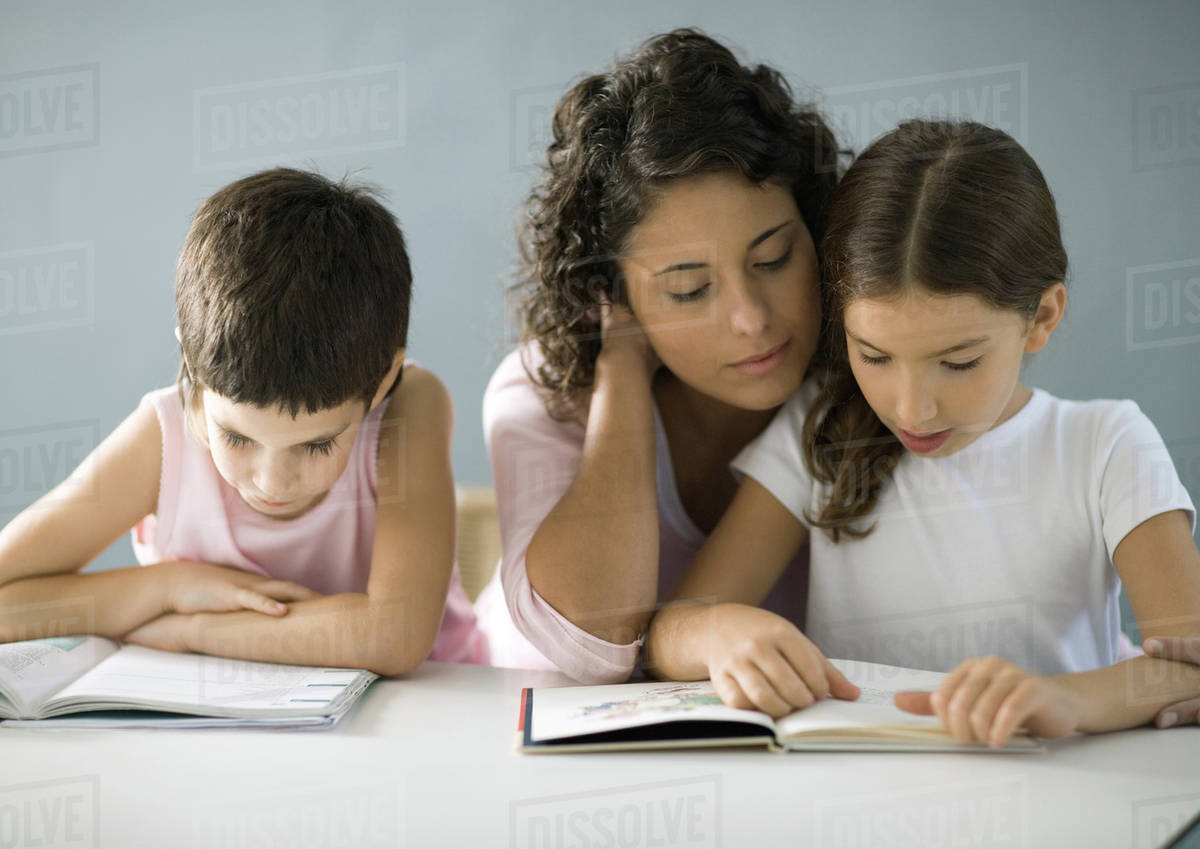 Mother helping children with homework - Royalty-free Stock Photo | Dissolve