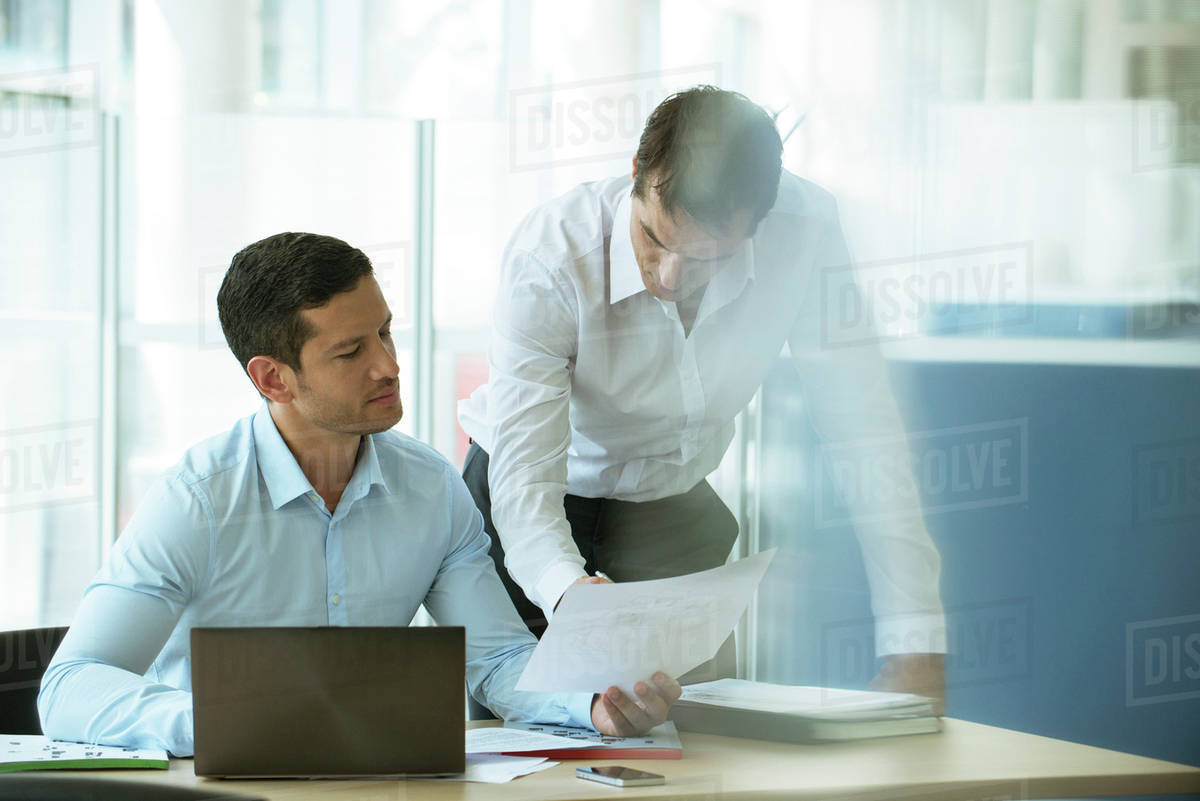 Businessmen reviewing document together - Royalty-free Stock Photo ...