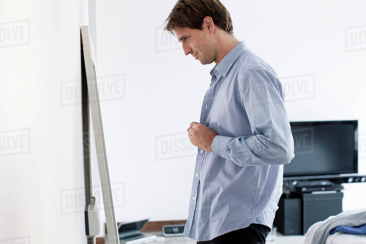 Man buttoning shirt - Royalty-free Stock Photo | Dissolve