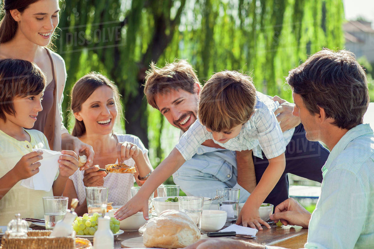 Family enjoying breakfast together outdoors - Royalty-free Stock Photo ...