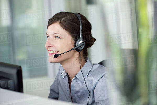 Receptionist wearing headset, smiling cheerfully - Royalty-free Stock ...