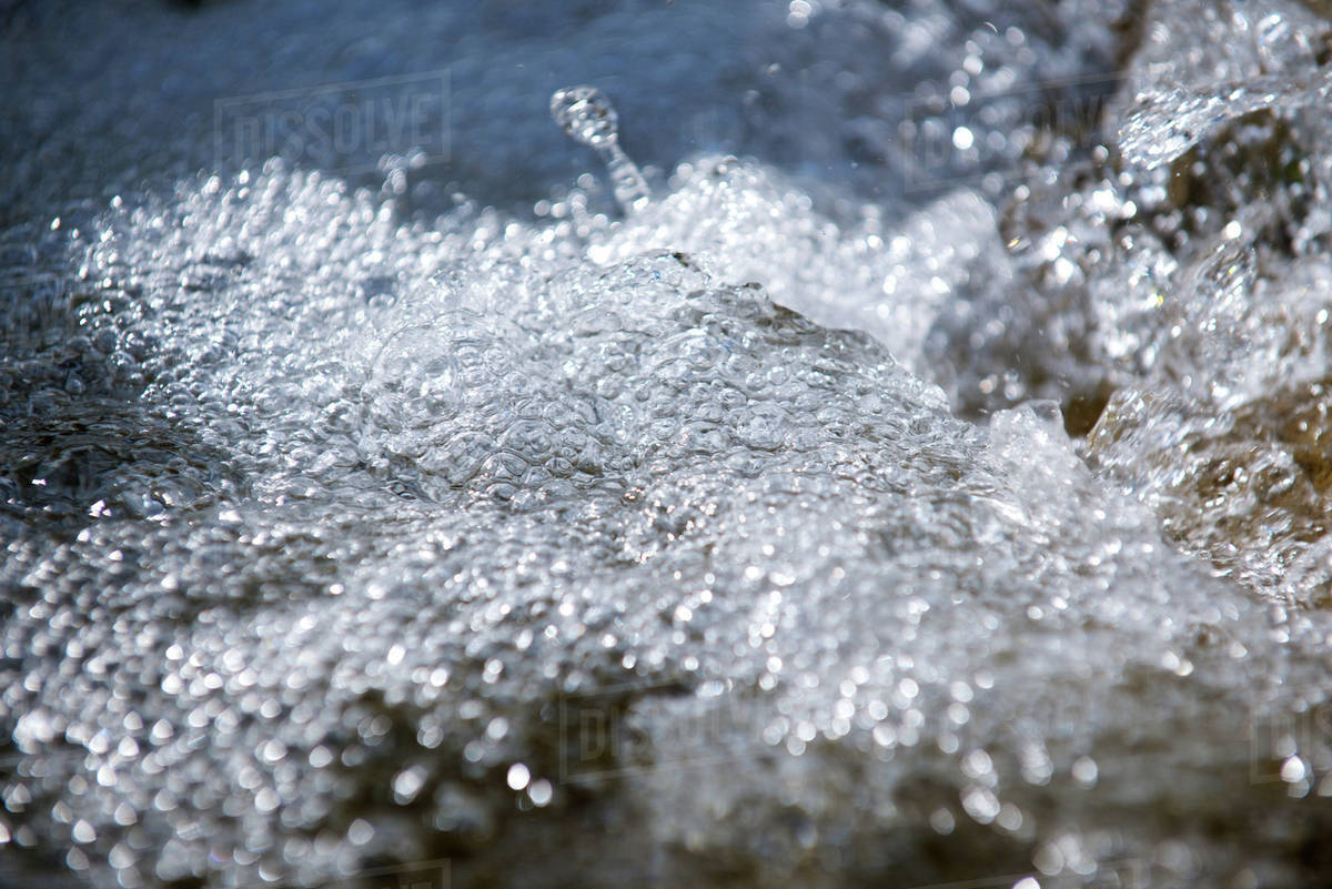 Bubbles on surface of flowing water - Royalty-free Stock Photo | Dissolve