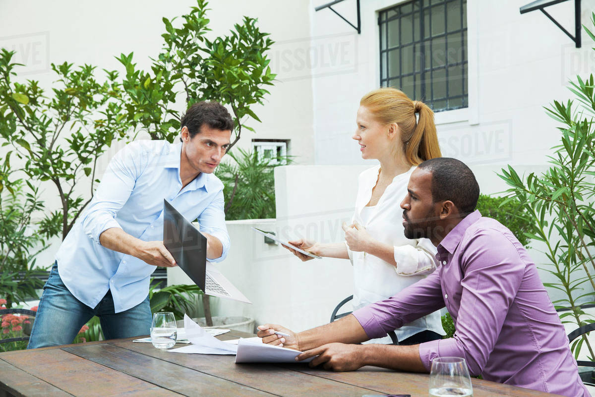 Businessman sharing good news with colleagues - Stock Photo - Dissolve