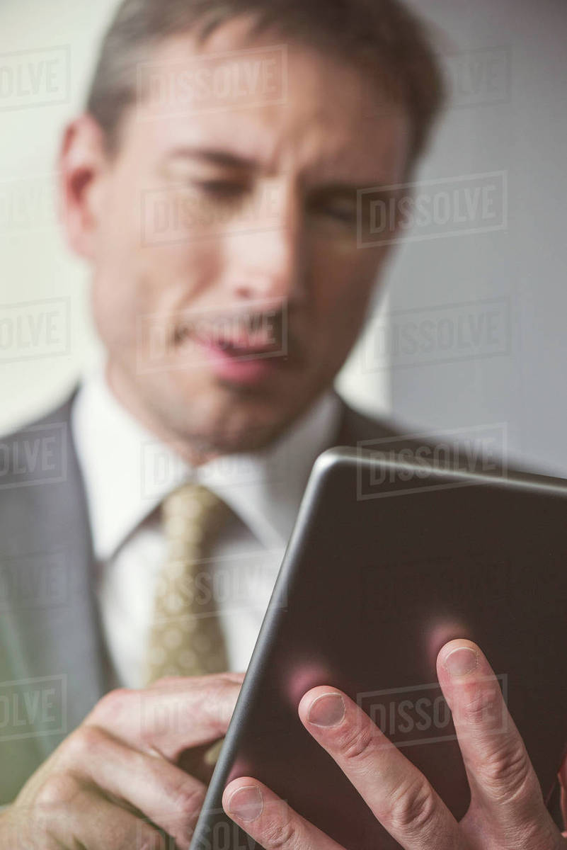 Businessman using digital tablet - Royalty-free Stock Photo | Dissolve