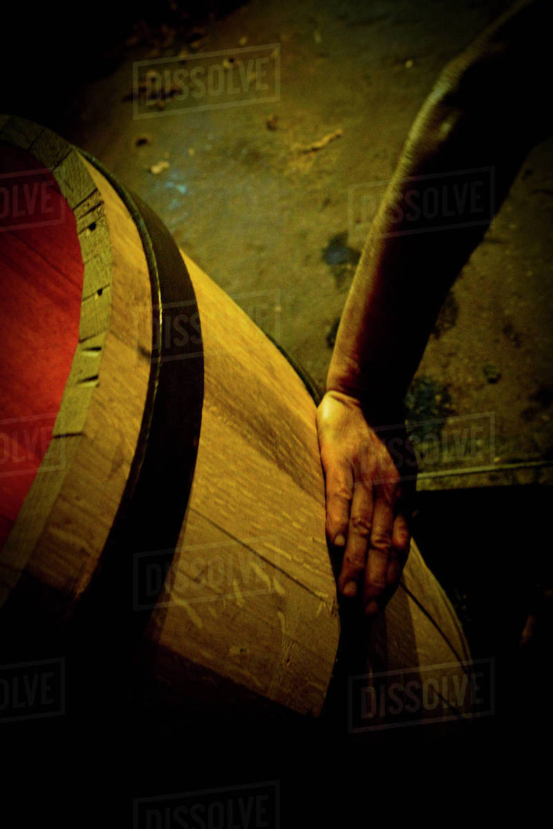 Hand touching wooden cask - Royalty-free Stock Photo | Dissolve