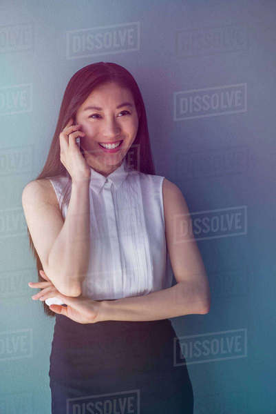 Woman smiling while talking on cell phone - Royalty-free Stock Photo ...