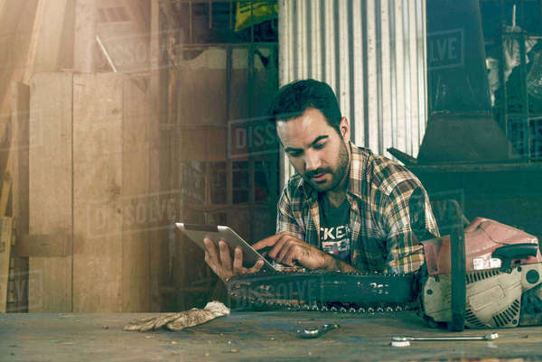 Man searching internet for chainsaw repair instructions - Stock Photo ...