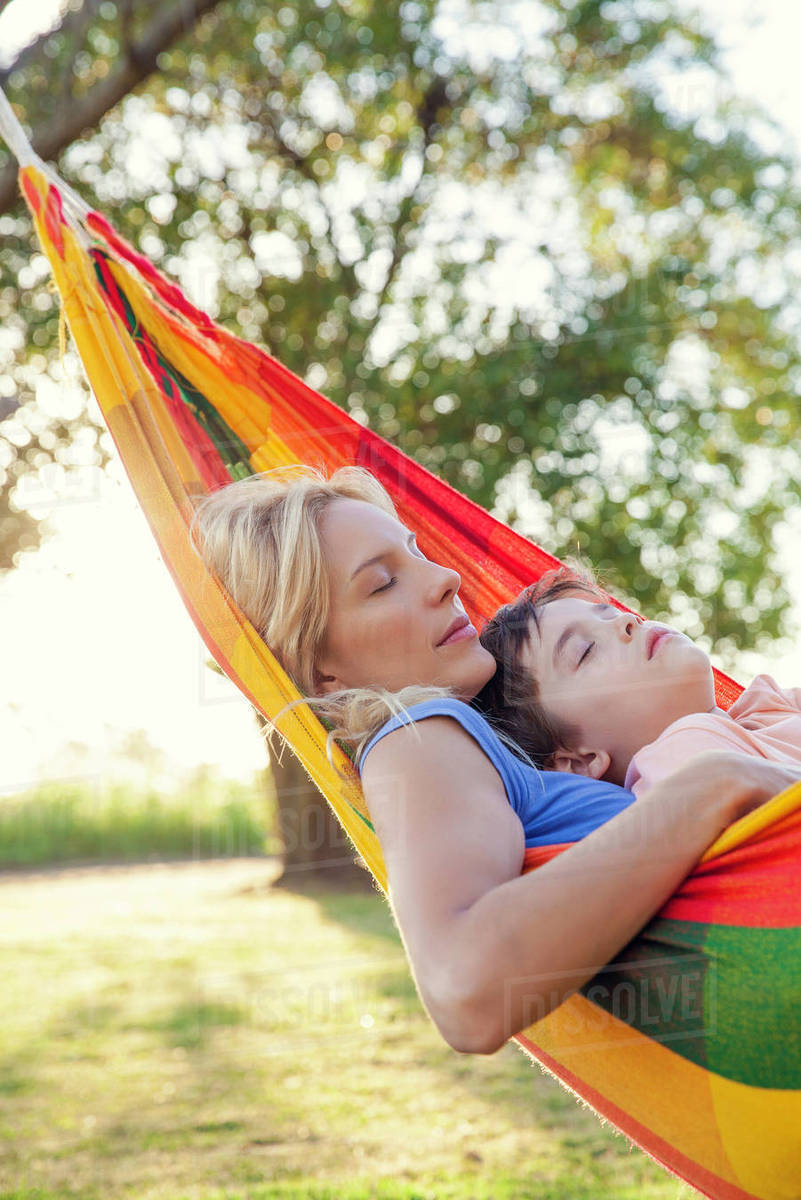 Mother and son napping together in hammock - Royalty-free Stock Photo ...