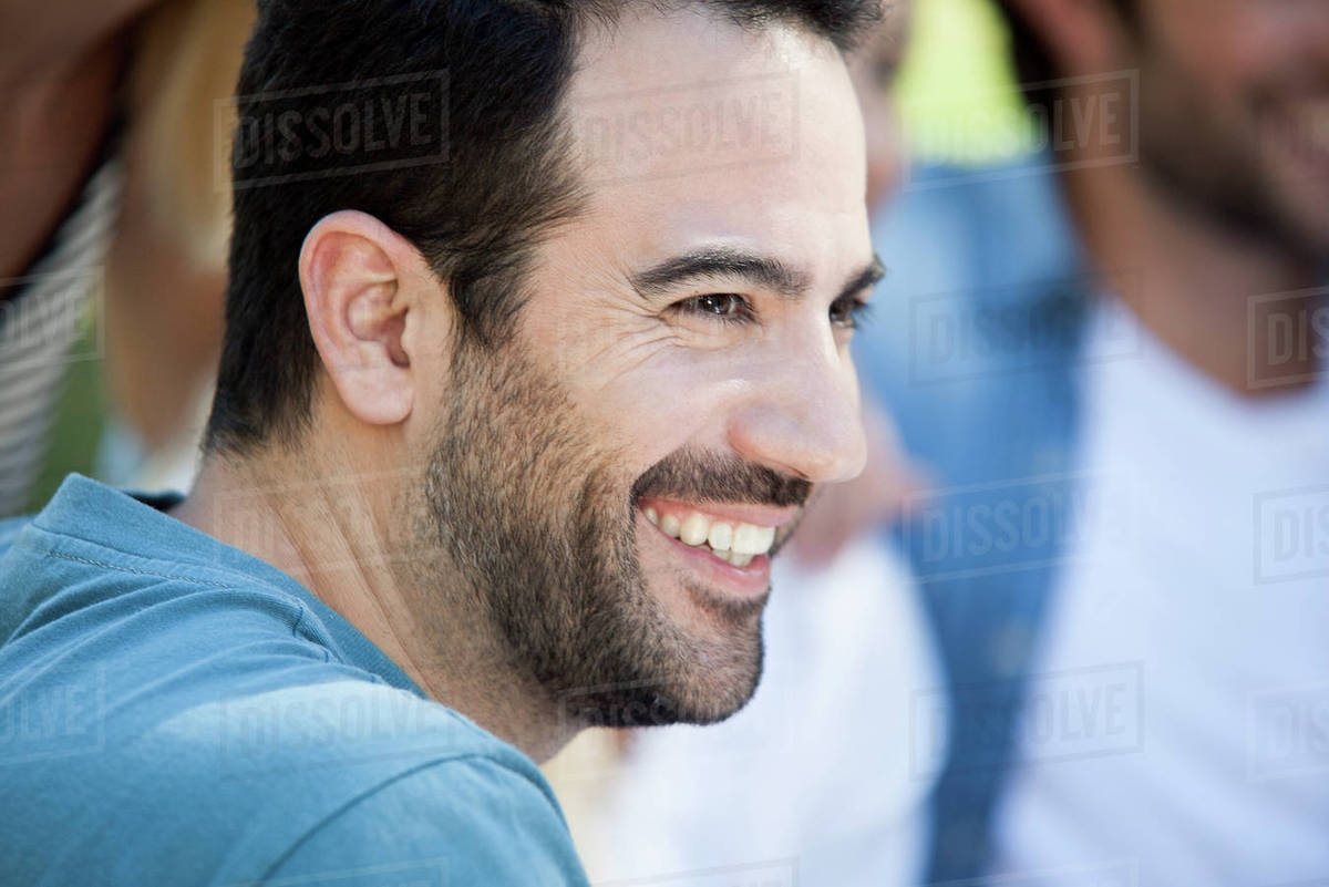 Man hanging out with friends outdoors - Stock Photo - Dissolve