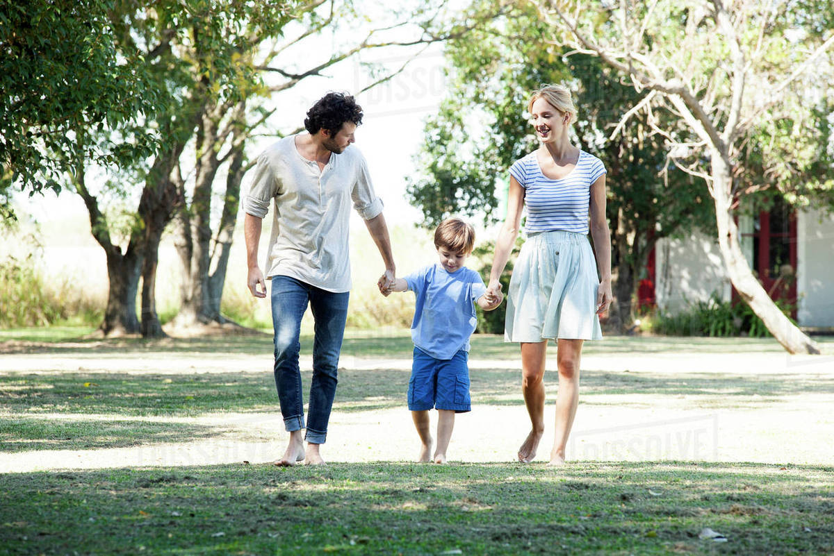 Family with one child taking walk outdoors together - Stock Photo ...