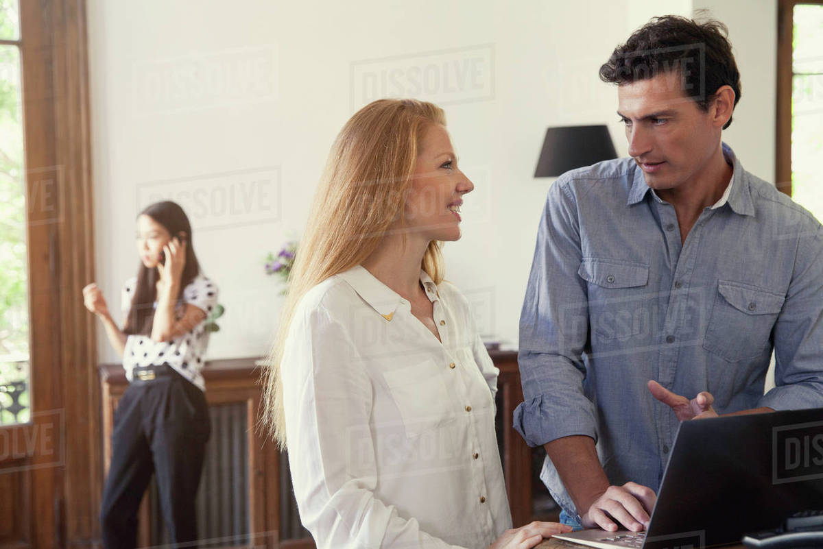 Colleagues talking together in office - Stock Photo - Dissolve