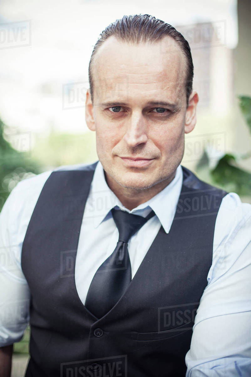Man smiling confidently, portrait - Stock Photo - Dissolve