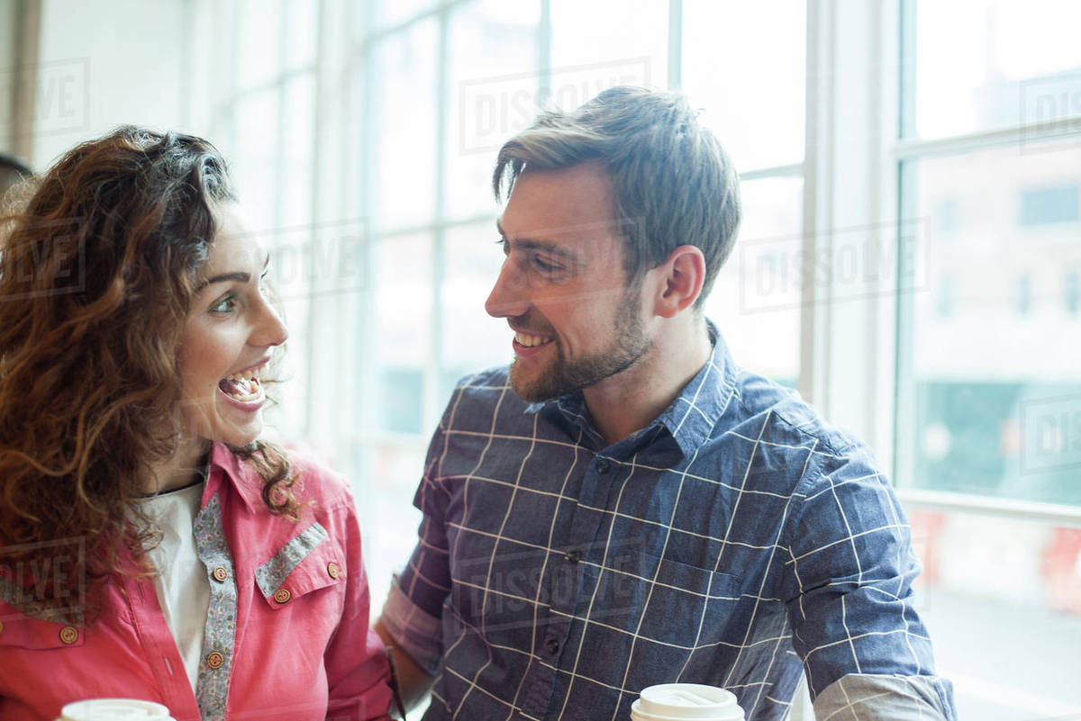 Cheerful couple talking together in coffee shop - Royalty-free Stock ...